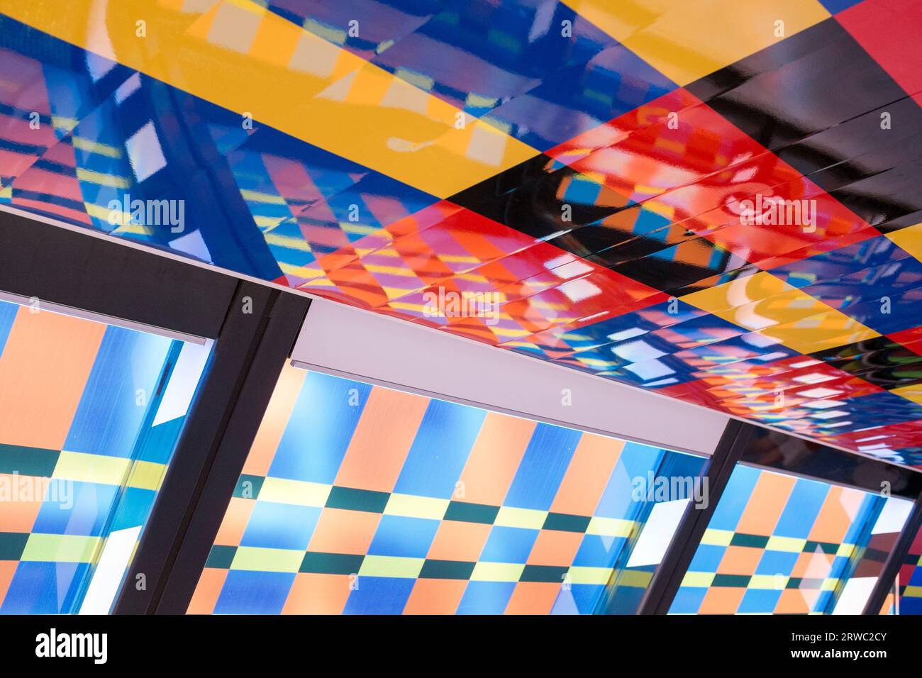Colourful walkway leading to Canary Wharf underground Station in London ...