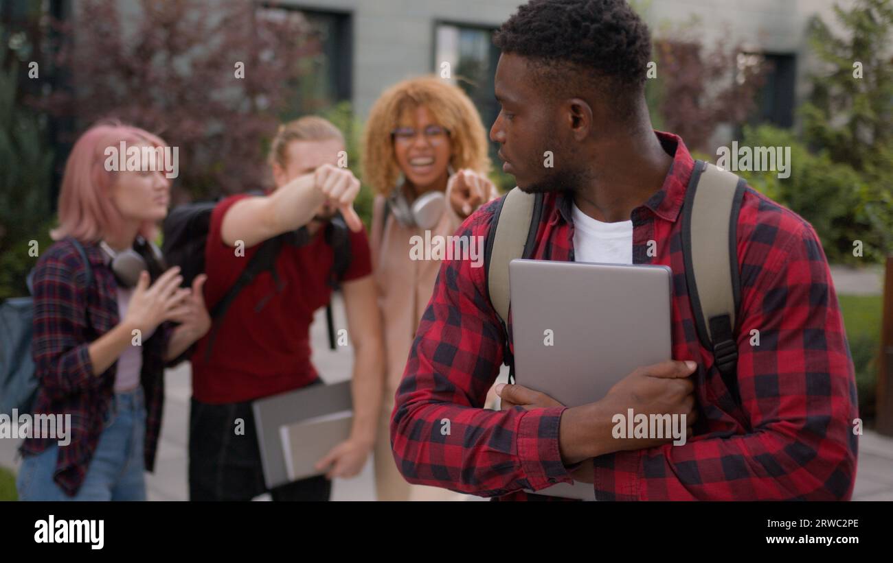 Sad upset offended victim boy student guy African American suffering ...