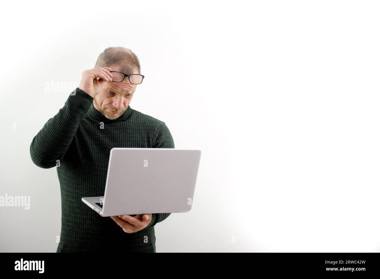 adult man with laptop wearing glasses looks at screen vision has fallen ...