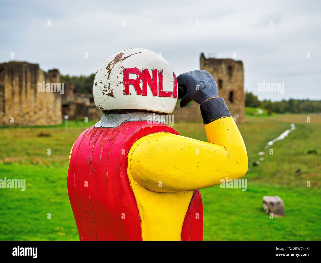 Statue of RNLI lifeboat man looking out to sea through binoculars ...