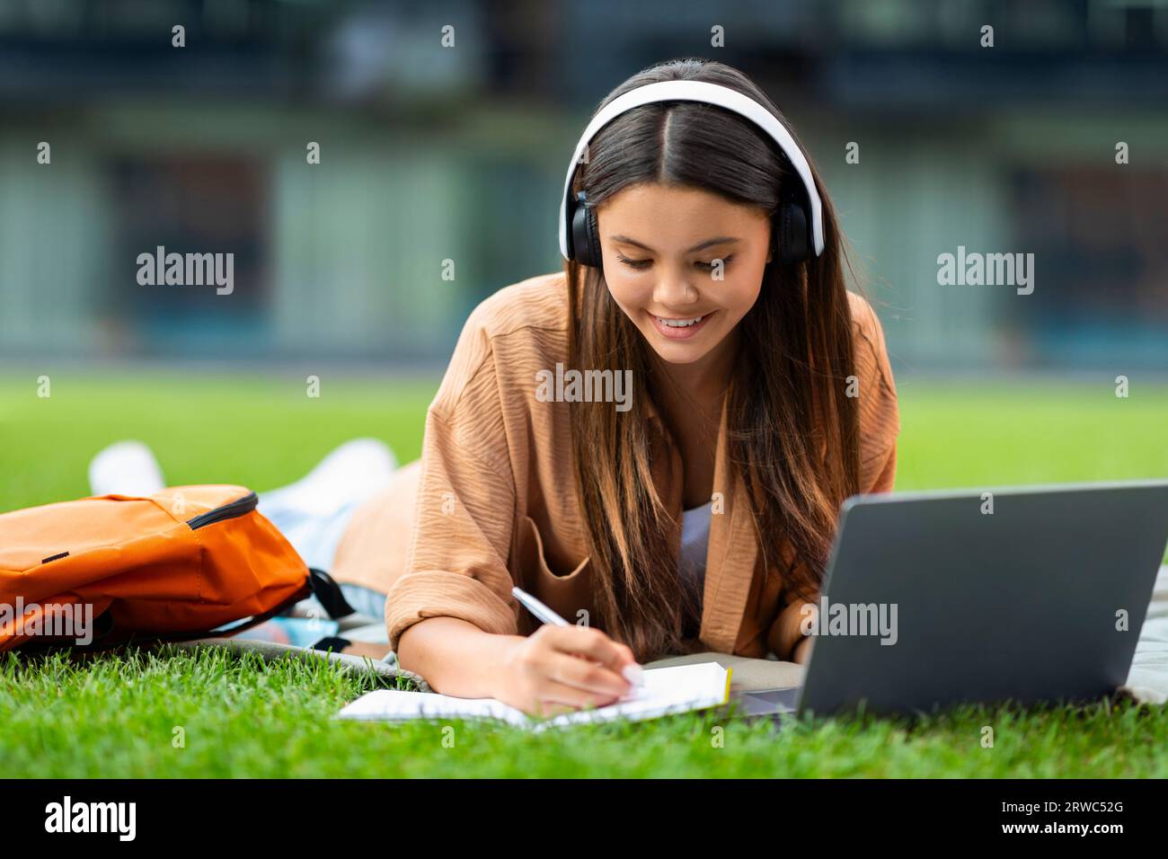 Smart young woman student chilling at park, attending webinar Stock ...