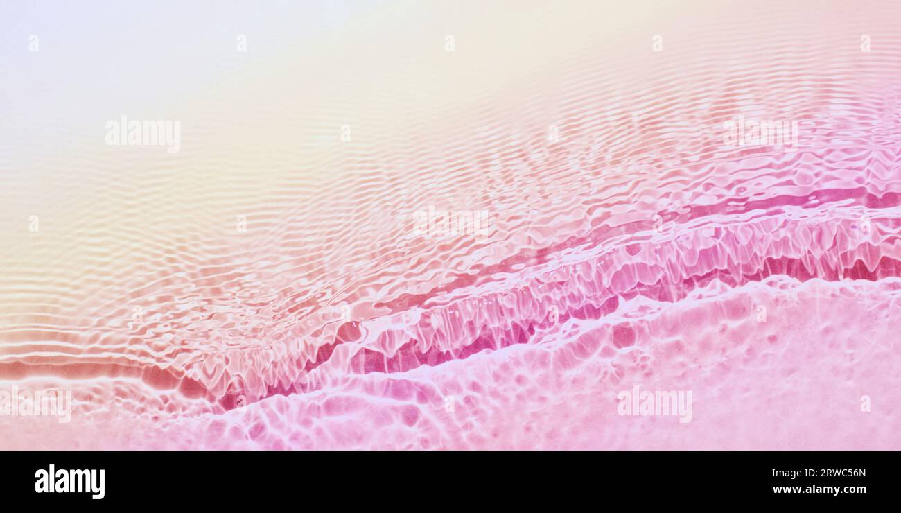 The texture of the water is tinted in pink color. Bright summer sea ...