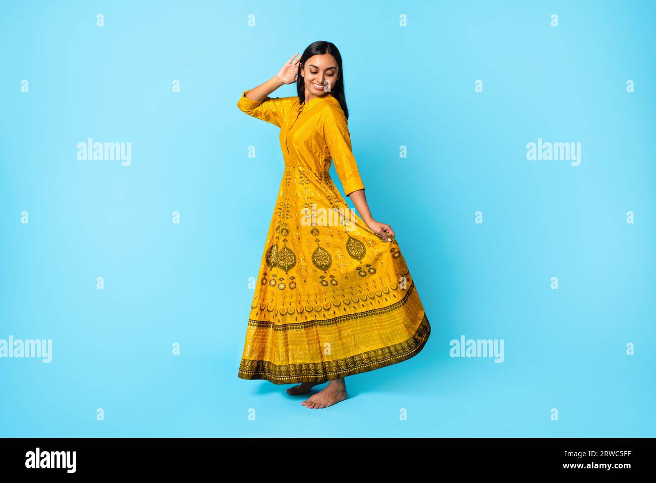 Young Indian Lady Wearing Yellow Traditional Dress Dancing, Blue ...