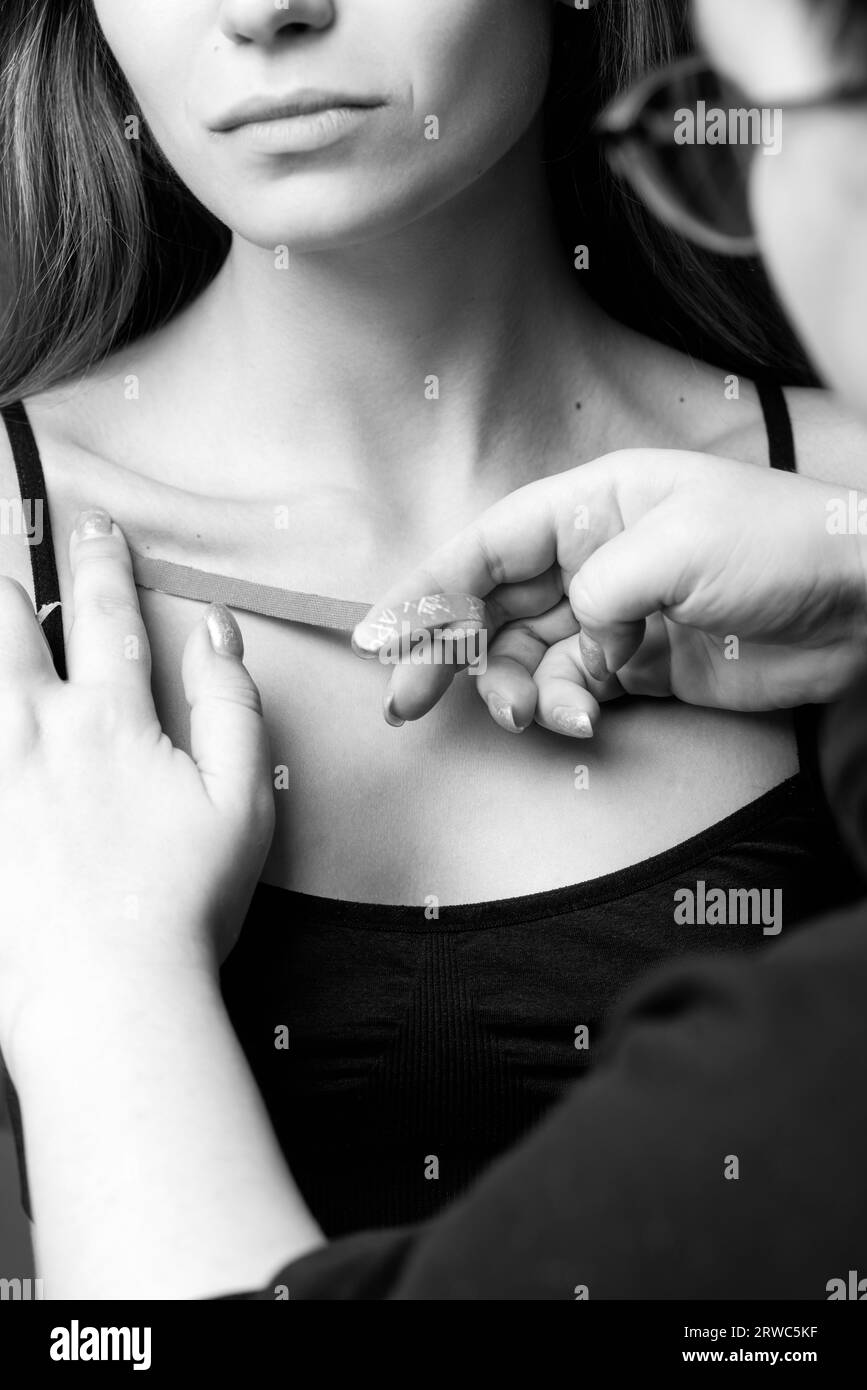 Kinesiology taping. Kinesiology tape on patient chest. Young female ...