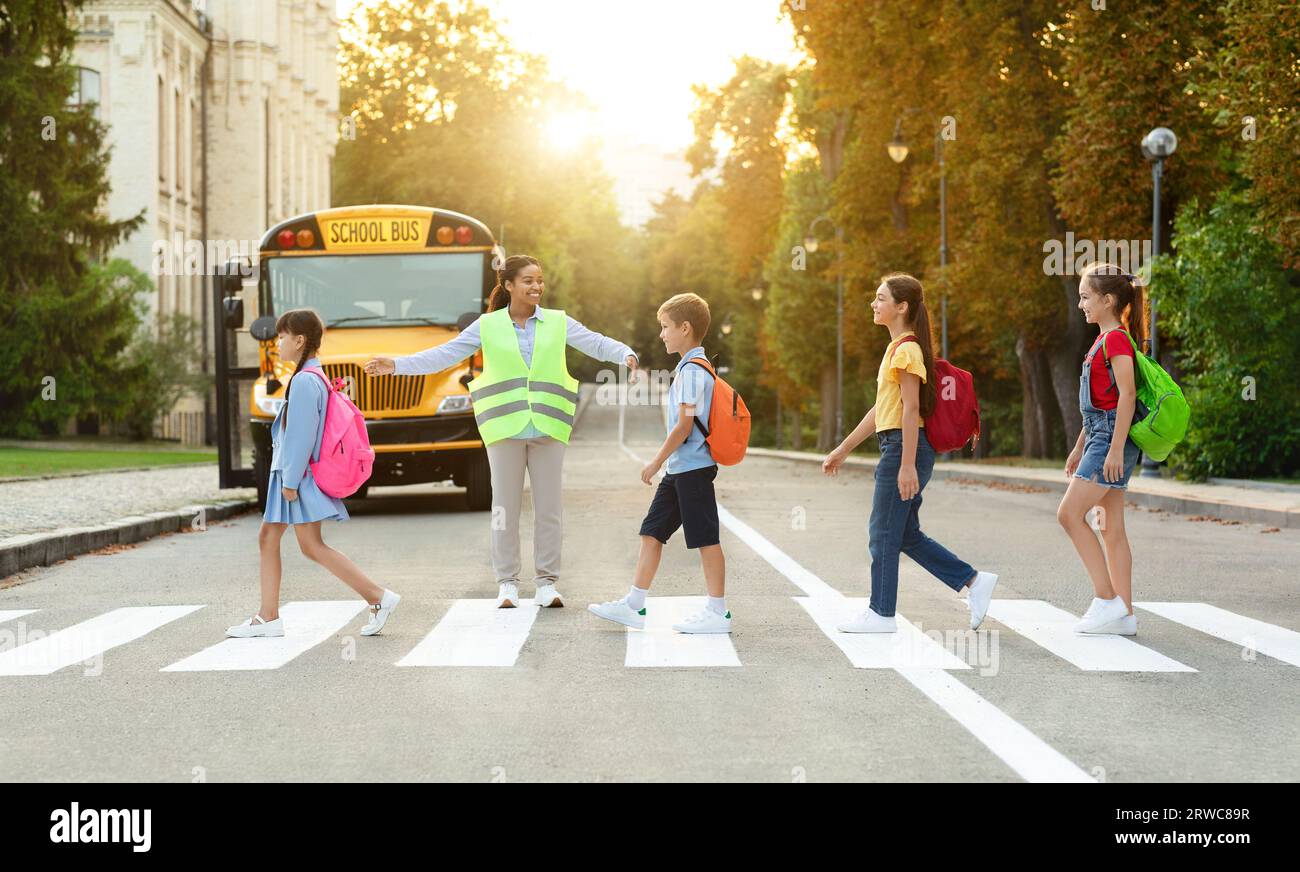 Group of children passing crosswalk on their way to school bus Stock Photo - Alamy