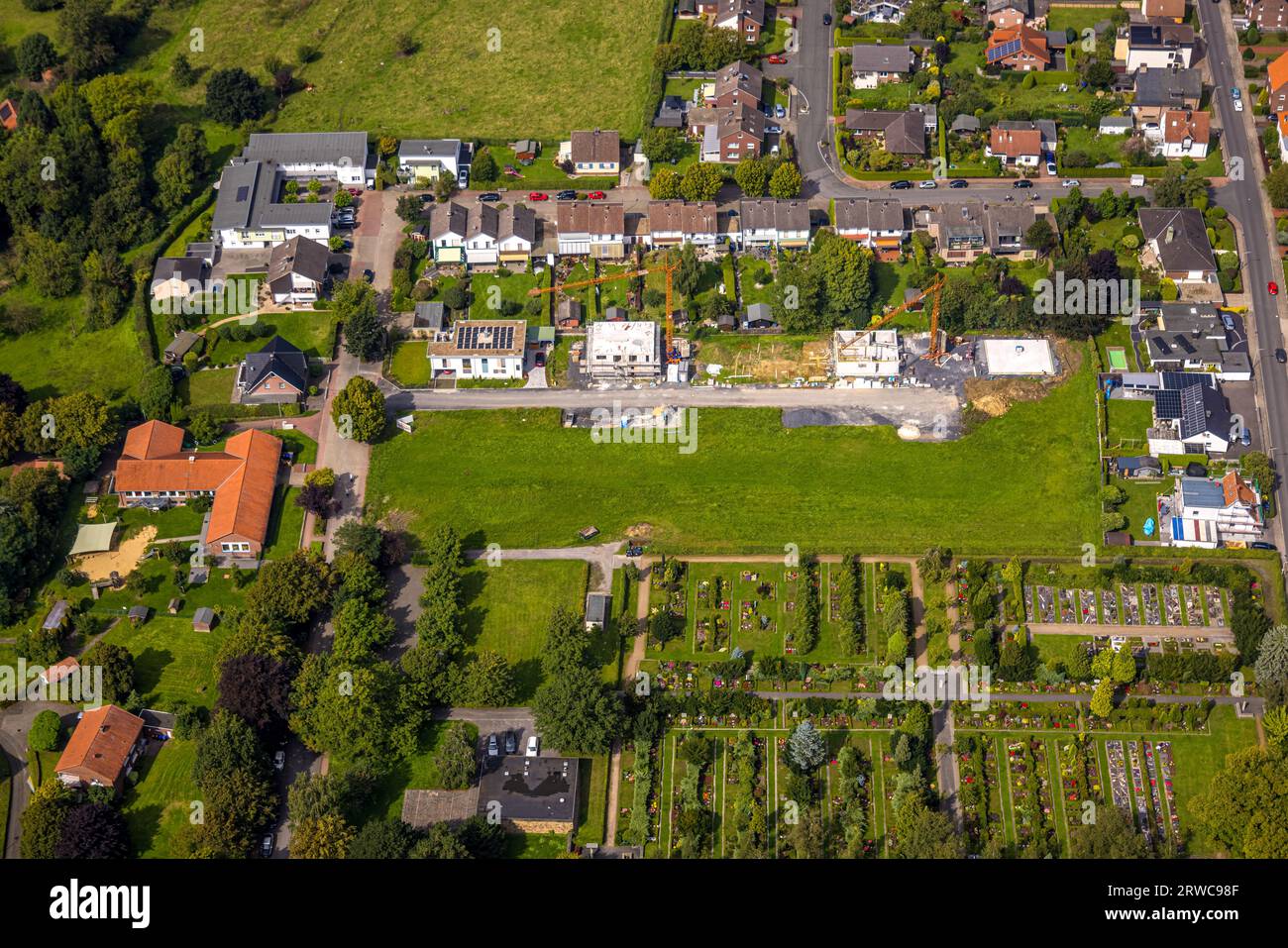 Aerial view, construction site with new building and green meadow ...