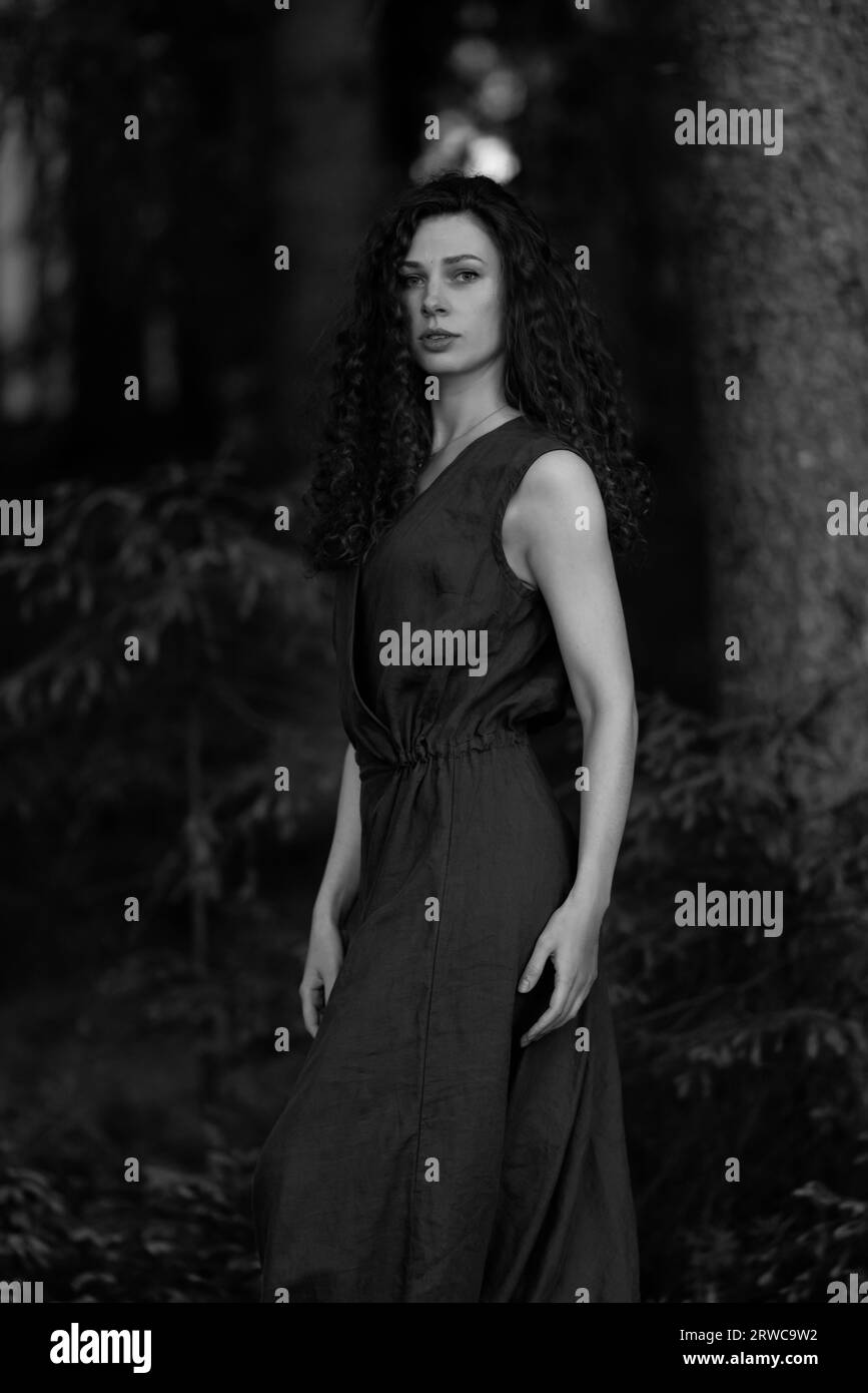 Young, beautiful skinny brunette posing in a forest grove. Young ...