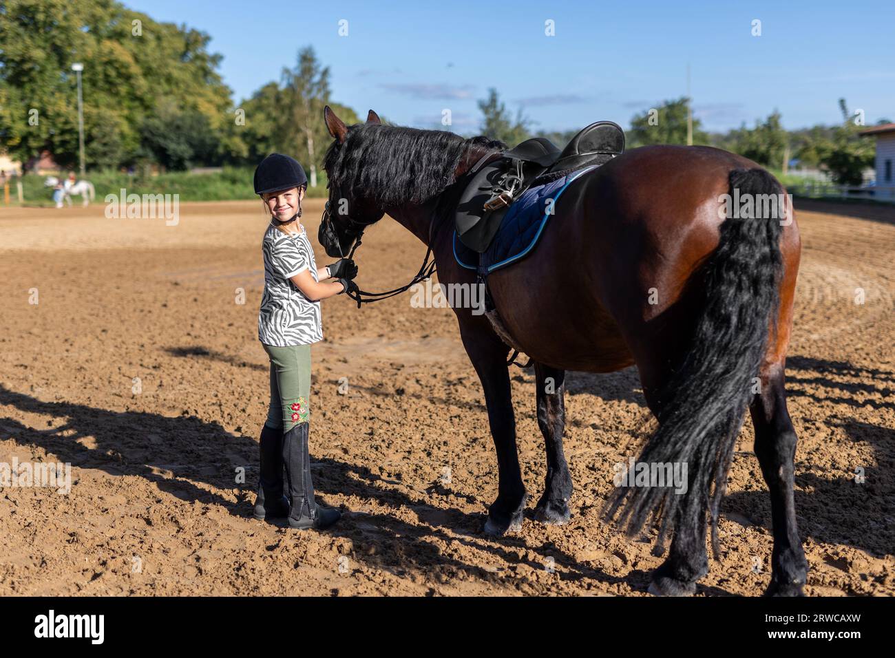 Horse riding school. Little children girls at group training equestrian ...