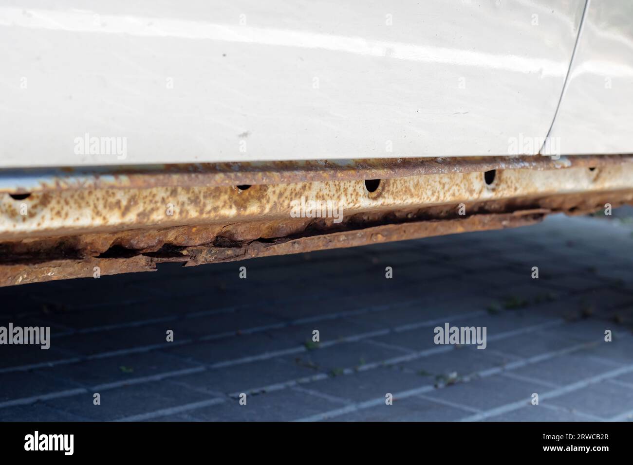 Rotten sills of an old gray car Stock Photo - Alamy