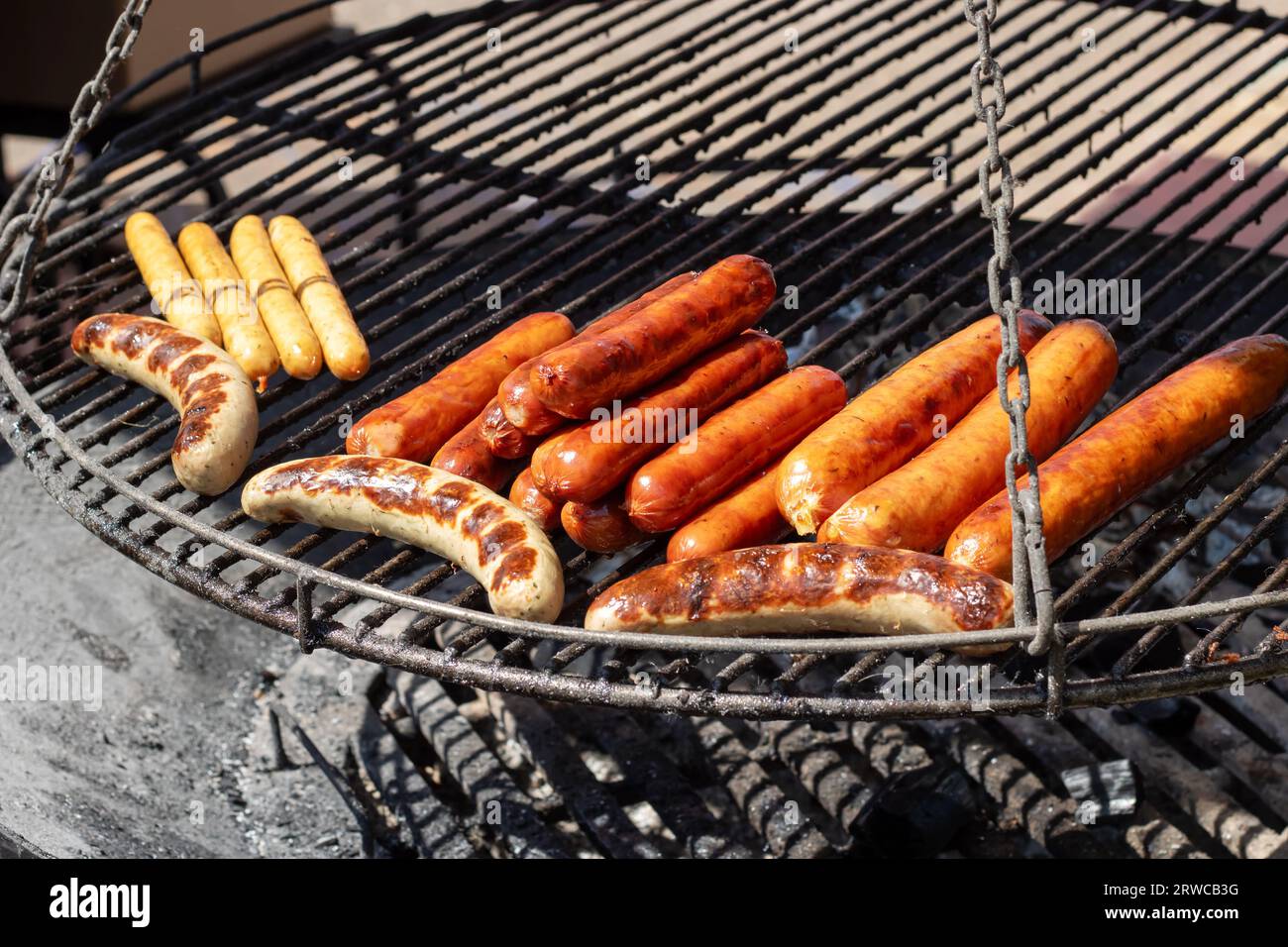 Grilled sausages on grill on flame closeup Stock Photo - Alamy