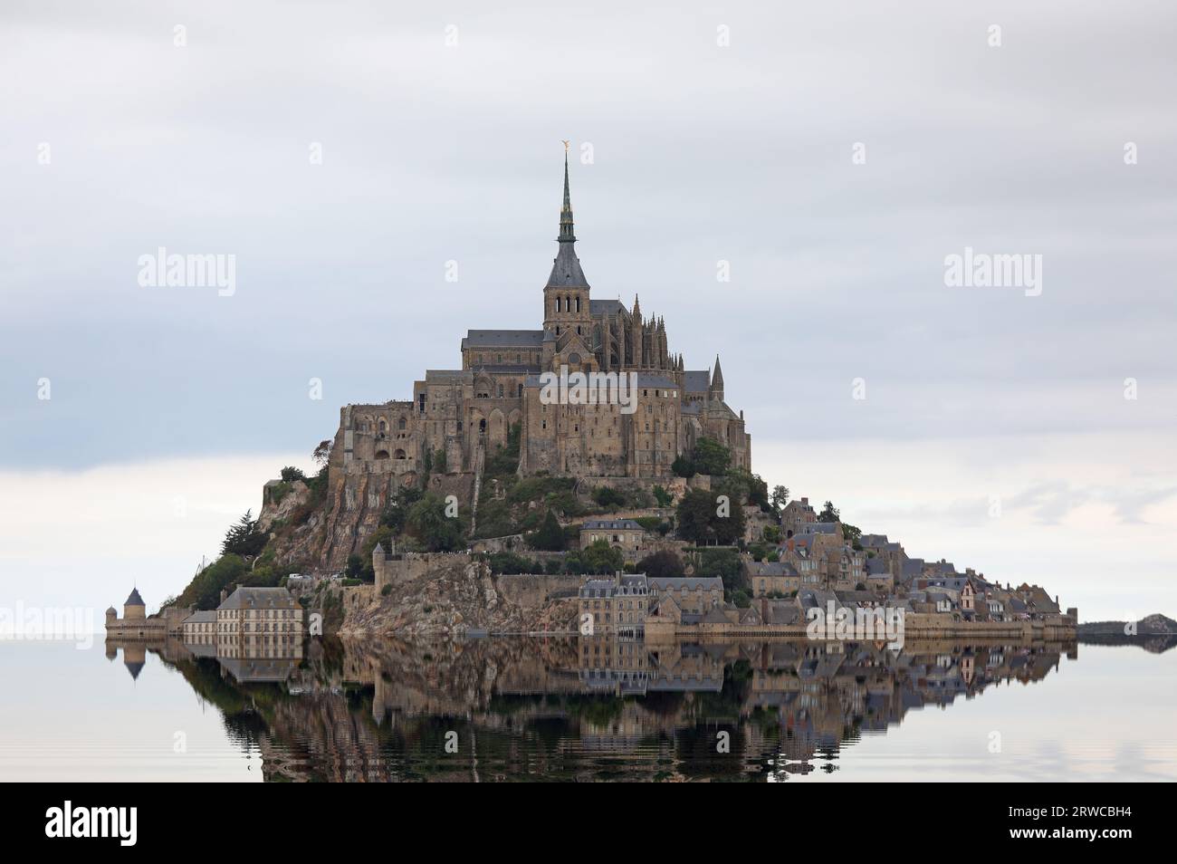 Reflection on the sea water during high tide and the hill with the ...