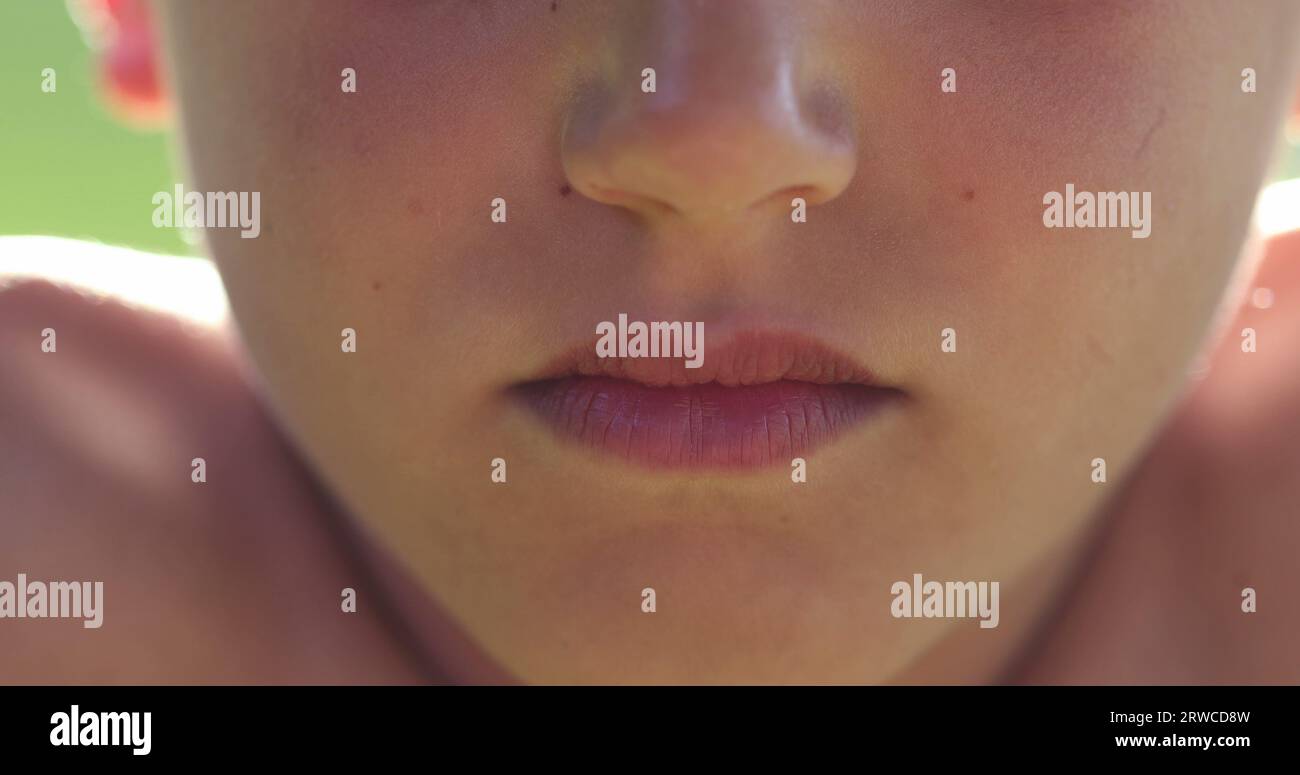 Upset child boy changing emotion becoming serious. Macro close-up kid ...