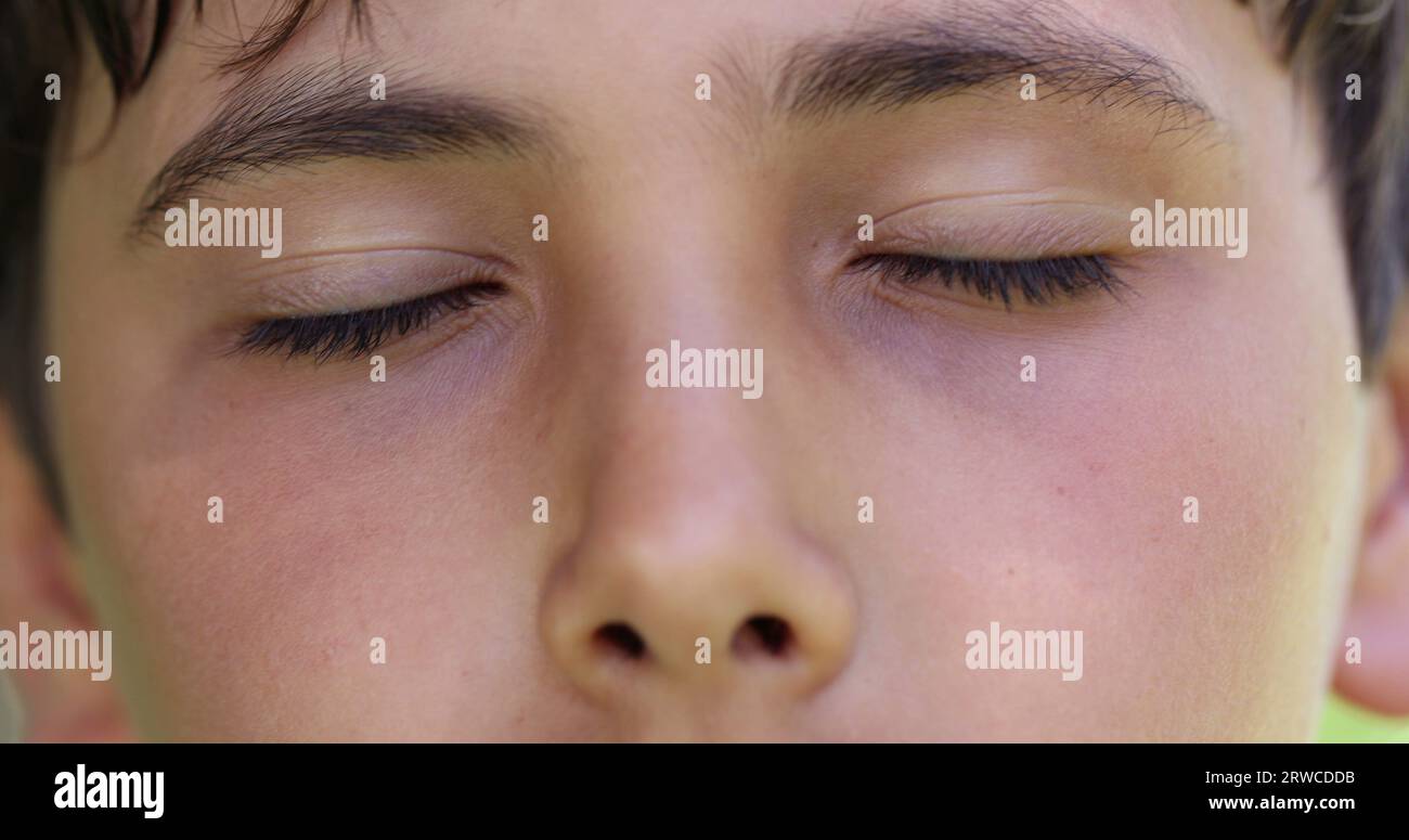 Young boy closing eyes in contemplation and meditation. Pensive ...