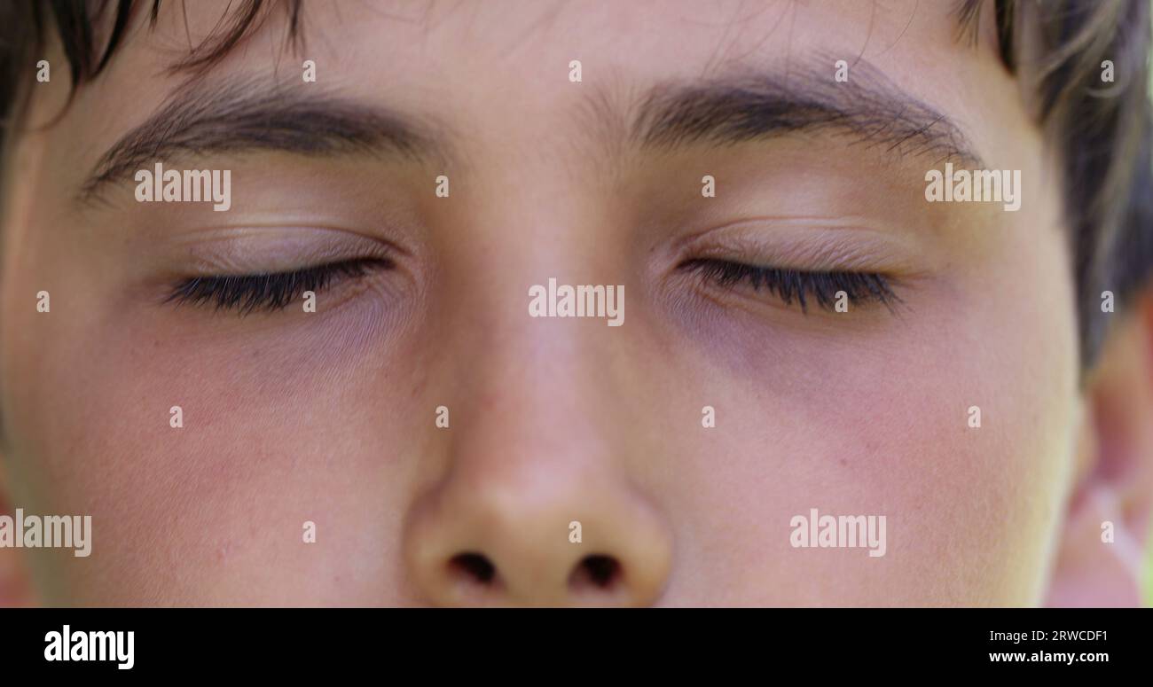 Young boy closing eyes in contemplation and meditation. Pensive ...