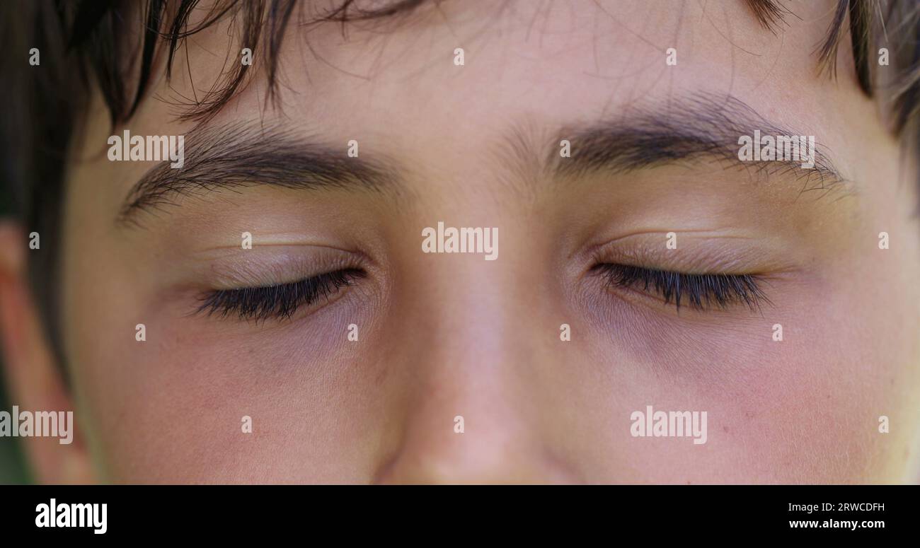 Young boy closing eyes in contemplation and meditation. Pensive ...