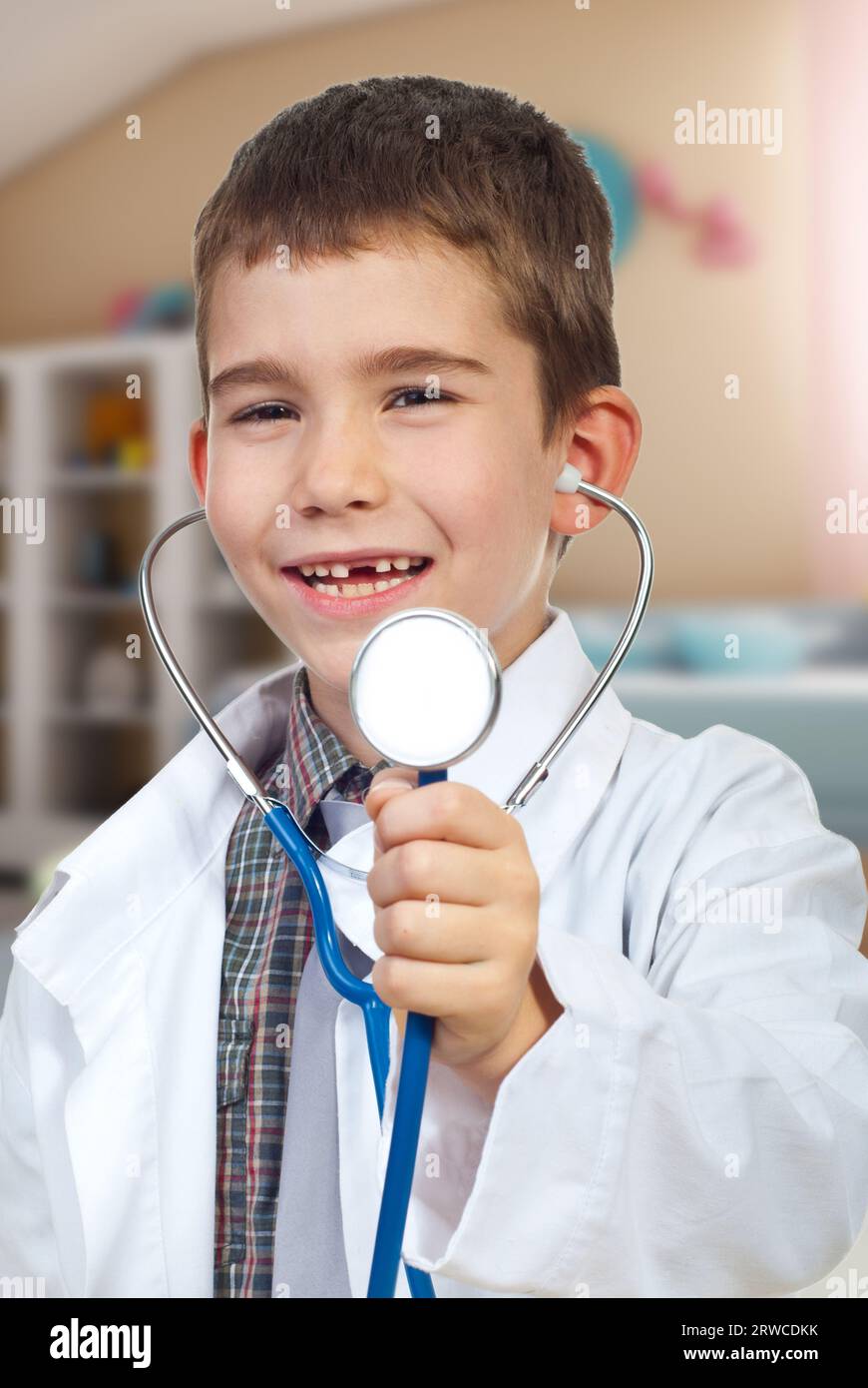 Small doctor boy holding stethoscope and laughing isolated on white ...