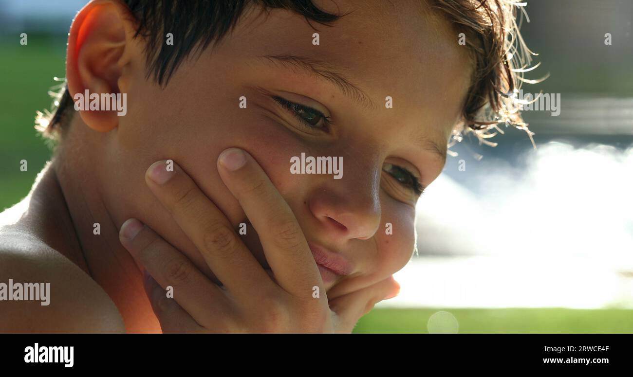 Pensive child boy thinking with hand in chin. Contemplative thoughtful ...