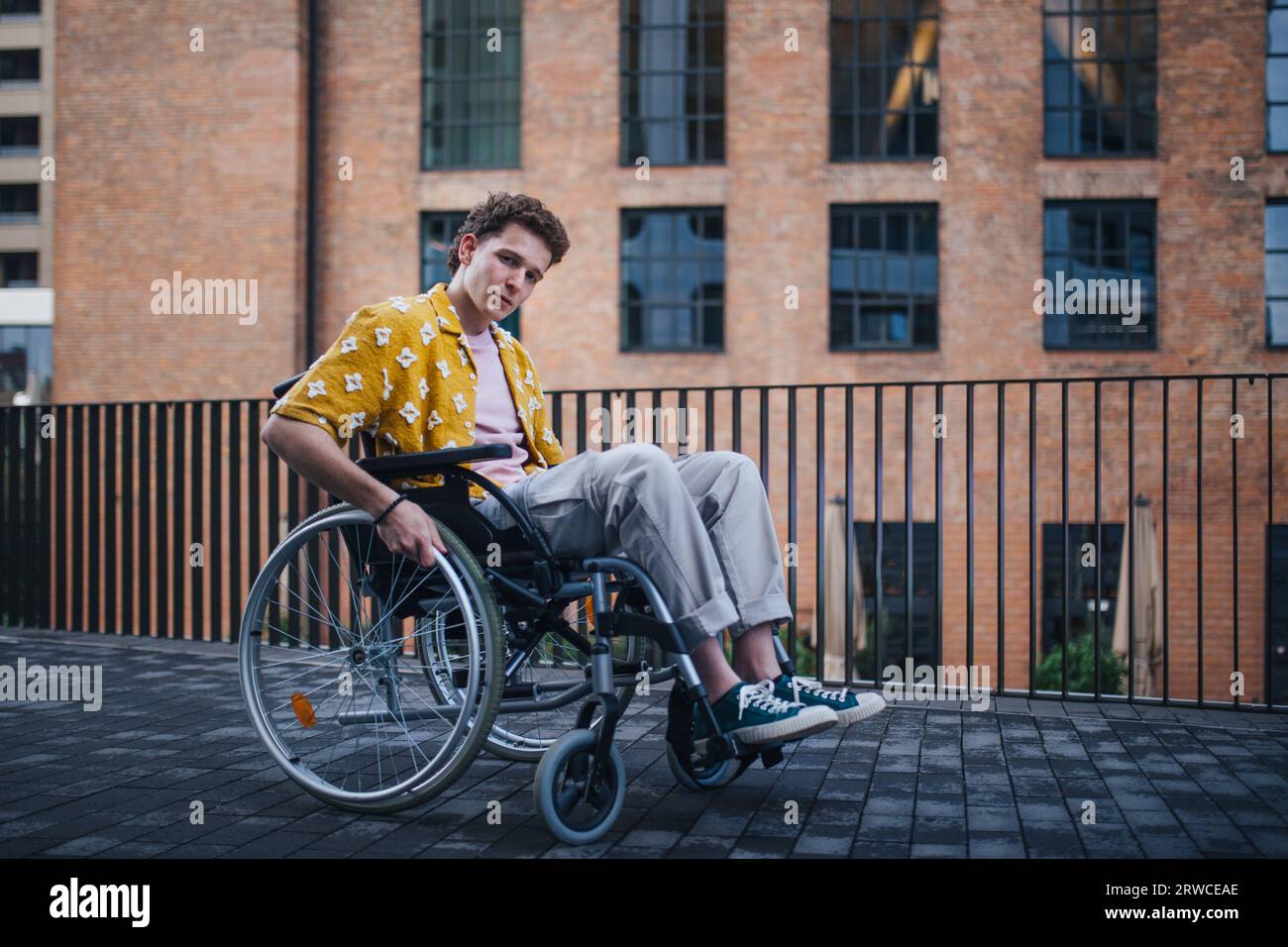 Gen Z boy in a wheelchair in the city Stock Photo - Alamy