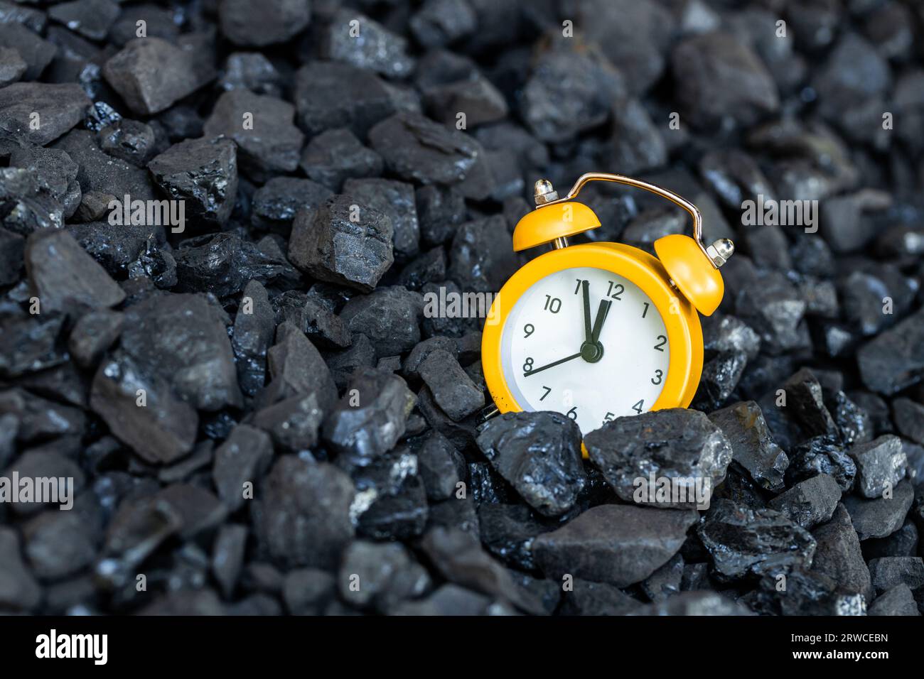 clock with an alarm for the twelve o clock furnace lying in a coal heap ...