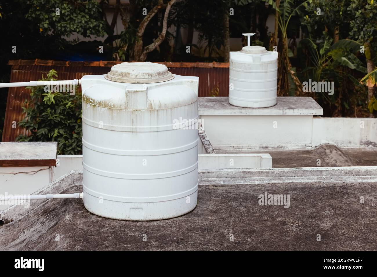 Two rooftop tanks for collecting and using water in a residential ...
