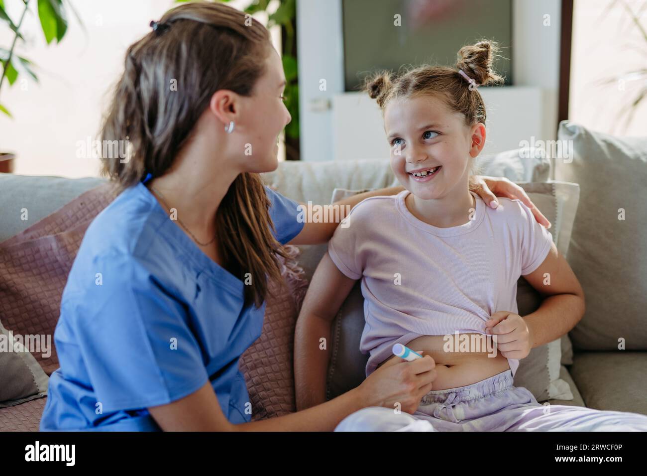 Nurse applying a continuous glucose monitor sensor to the arm of a ...