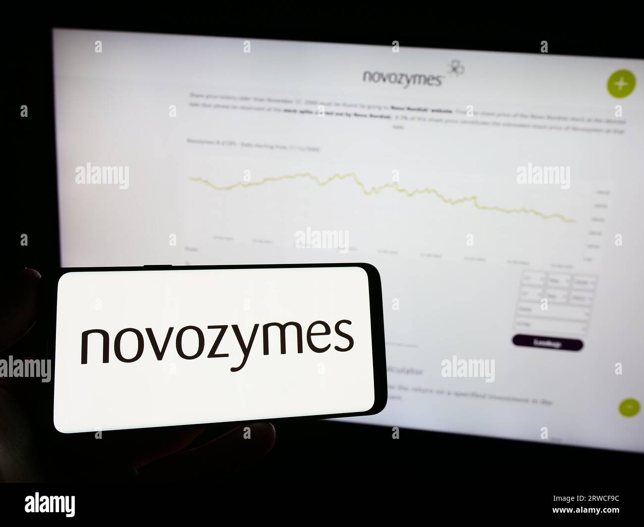 Person holding mobile phone with logo of Danish biotechnology company ...