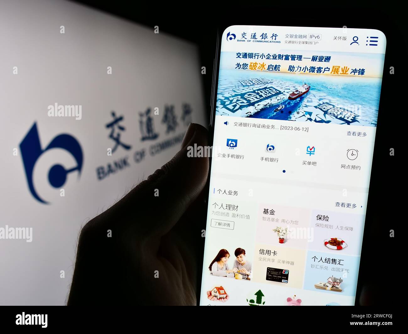 Person holding cellphone with webpage of Chinese company Bank of ...