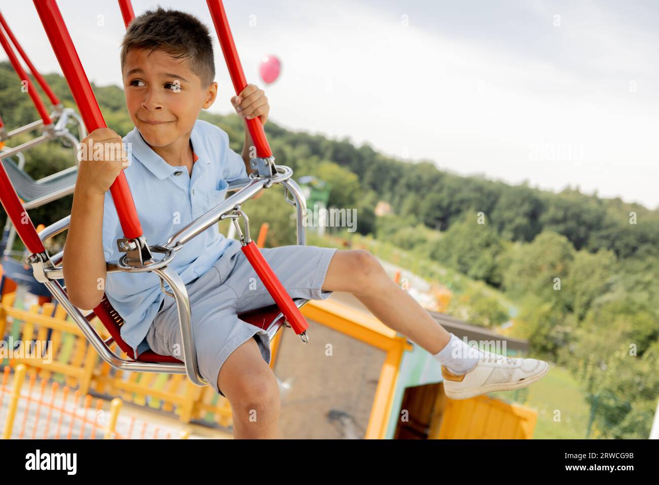 Kids riding on colorful amusement carousel Stock Photo - Alamy