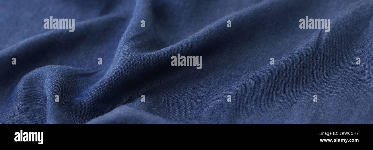Wavy blue textile as background. Blue unicolor fabric close up Stock ...