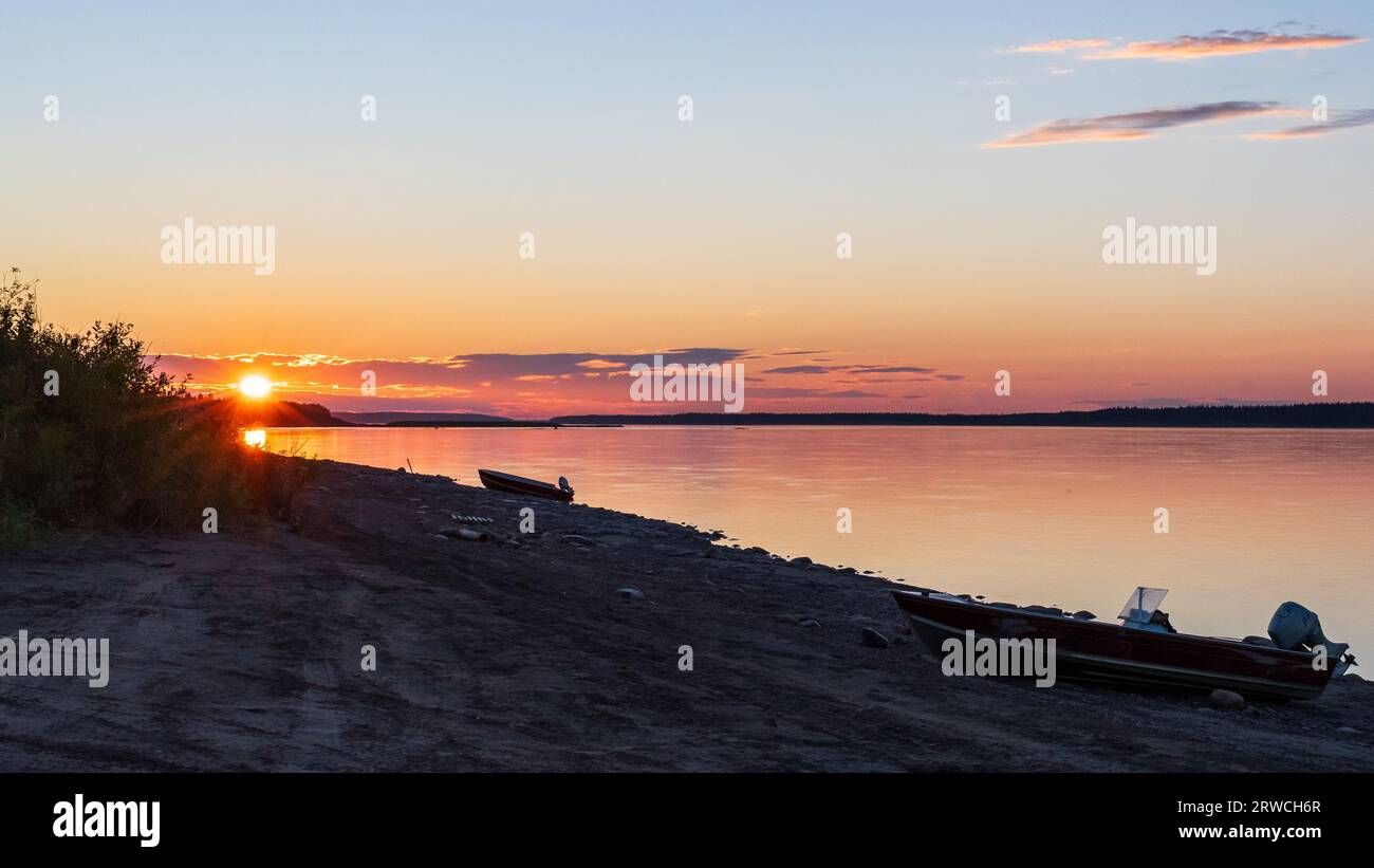 Boats Sit on the River’s Edge During a Beautiful Sunset in Fort Simpson ...