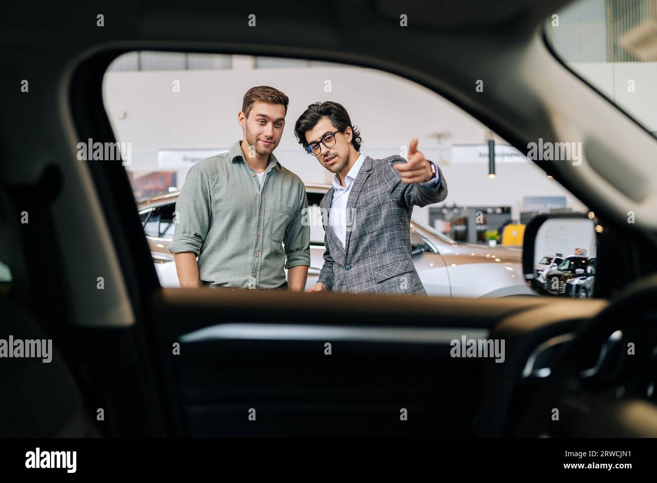 View from interior of luxury car to professional car dealer in business ...