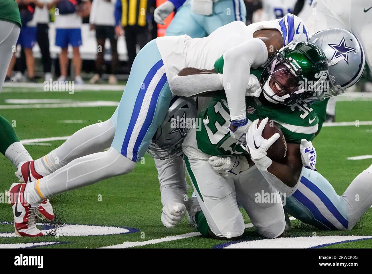 New York Jets running back Michael Carter (32) is tackled by Dallas ...