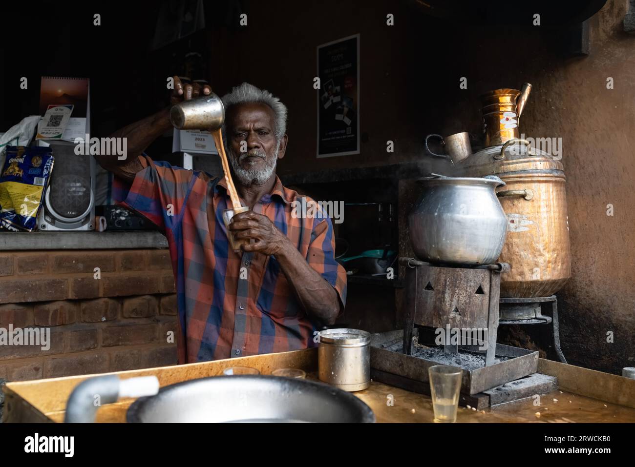 Tamil Nadu, India - 01-15-2023 - Local man preparing masala chai on the ...