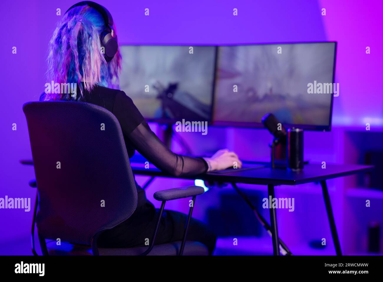 E-sport gamer girl plays first-person shooter online video game on PC ...