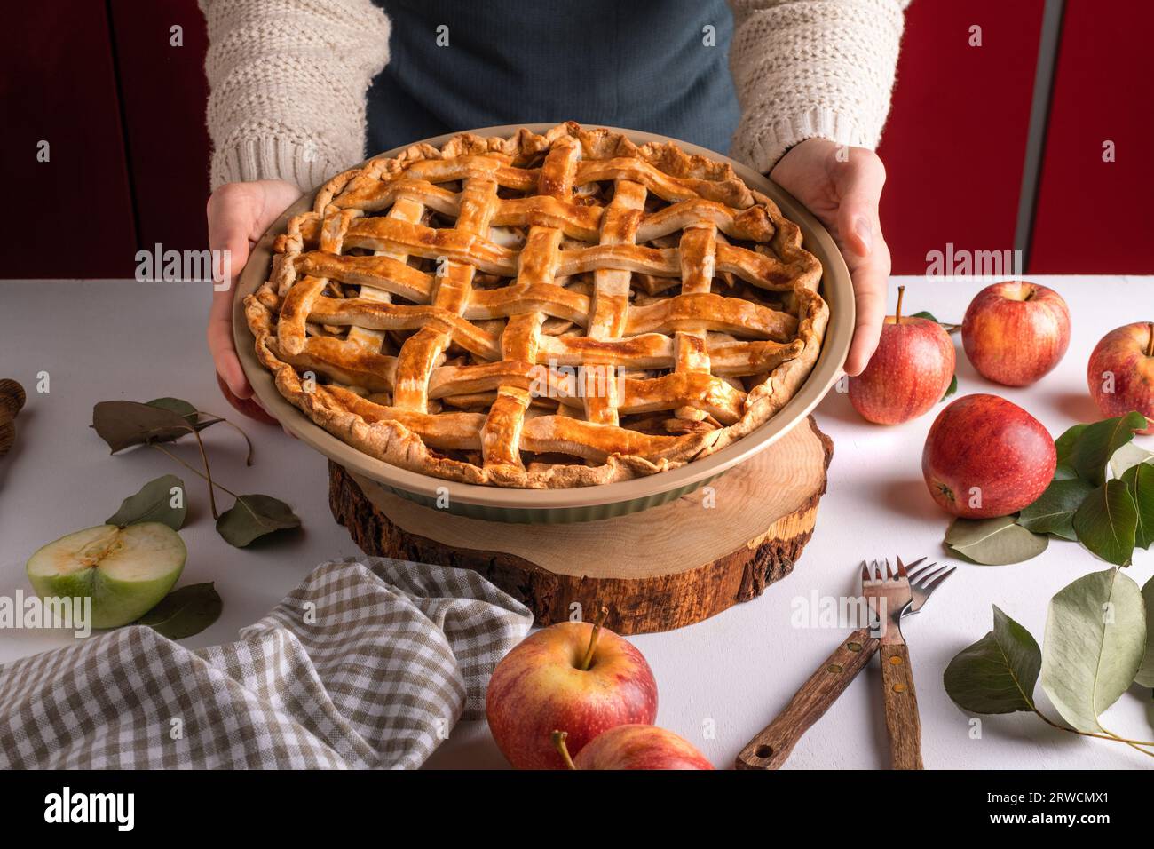 Woman holding and showing tasty cooked apple pie ready to be putting in ...