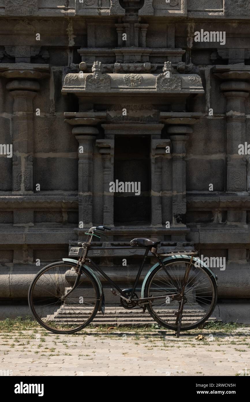 An old Indian bicycle against the backdrop of an ancient temple wall ...