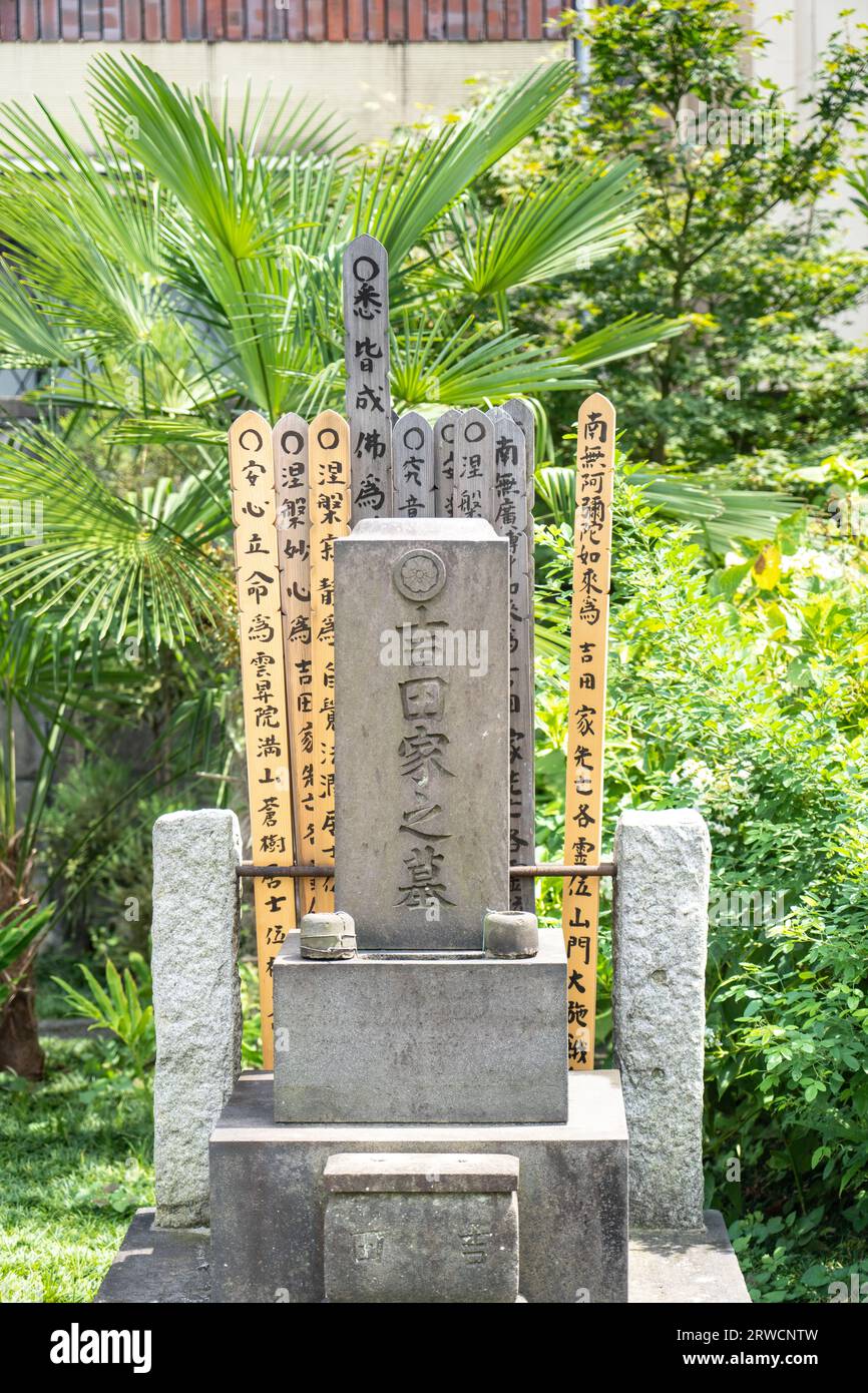 Traditional Buddhist style tomb marker surrounded by wooden planks ...