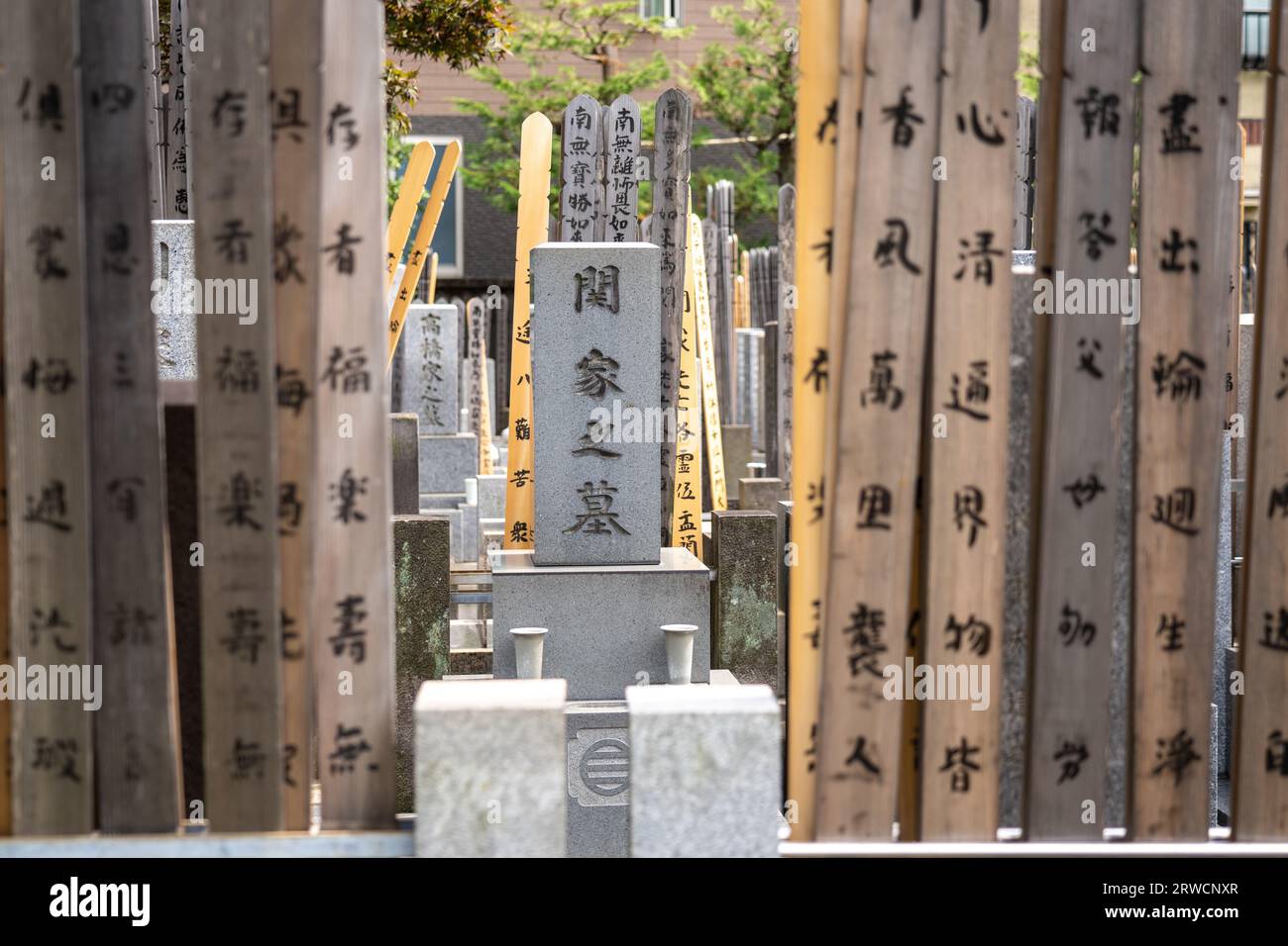 Traditional Buddhist style tomb marker surrounded by wooden planks ...