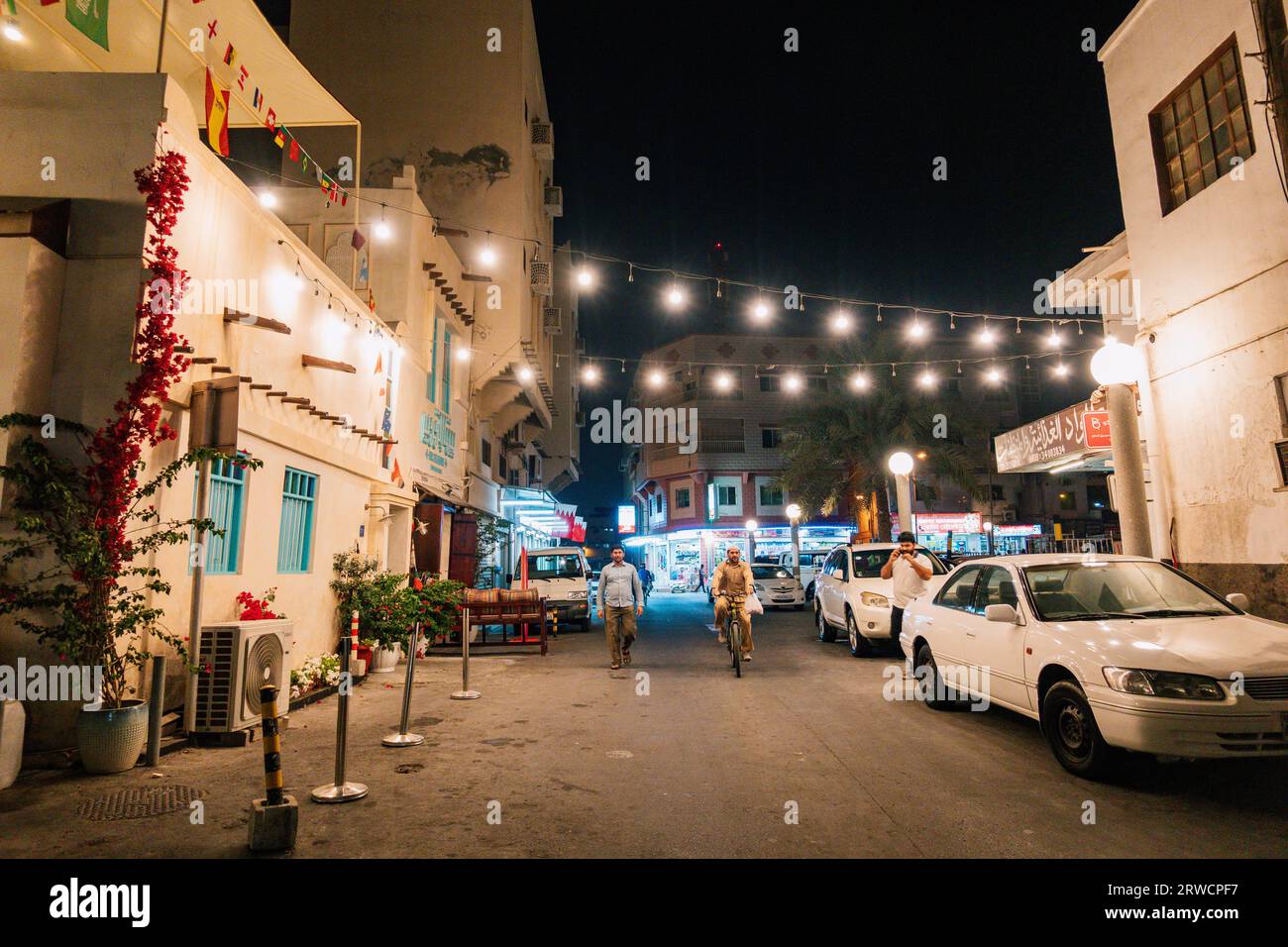 a string of lights from a restaurant hang across street at night in the ...