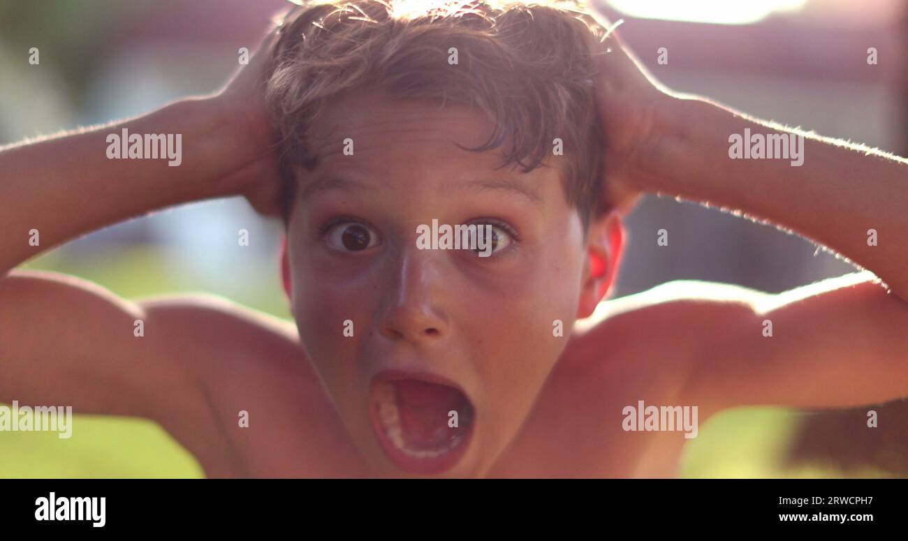 Young boy shock and surprise reaction, kid looking to camera feel ...