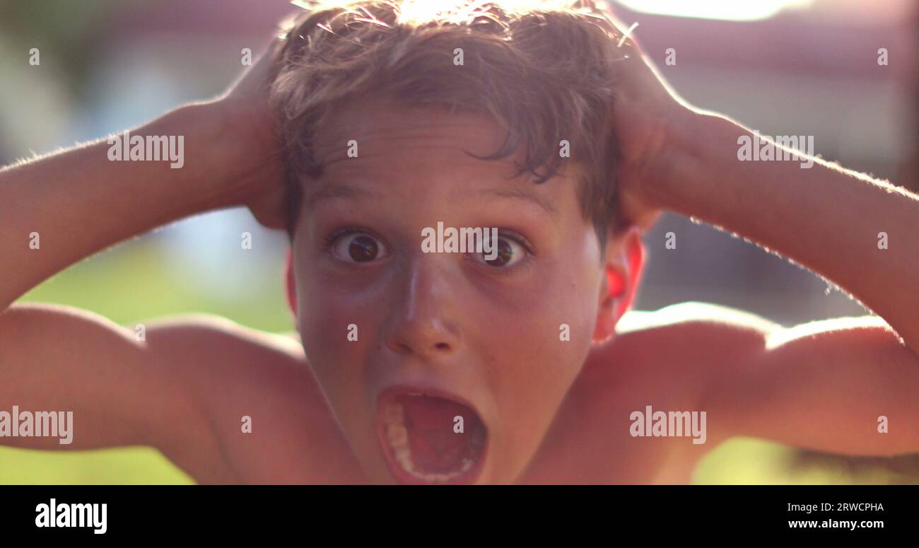 Young boy shock and surprise reaction, kid looking to camera feel ...