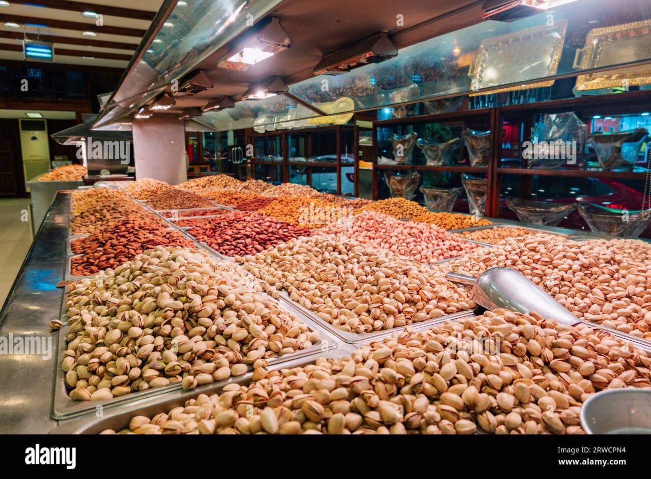 different varieties of nuts at a self-serve counter at a shop in the ...