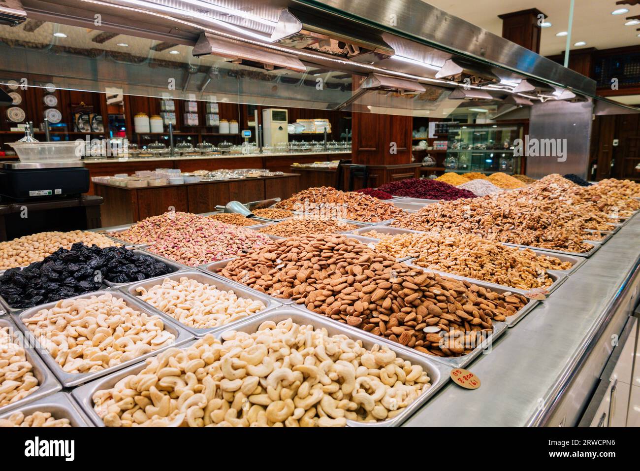 different varieties of nuts at a self-serve counter at a shop in the ...