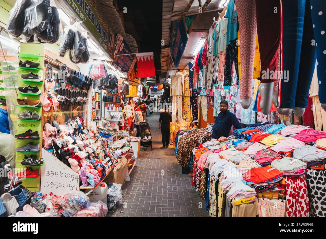 a street full of shops selling clothing, toys and other household items ...