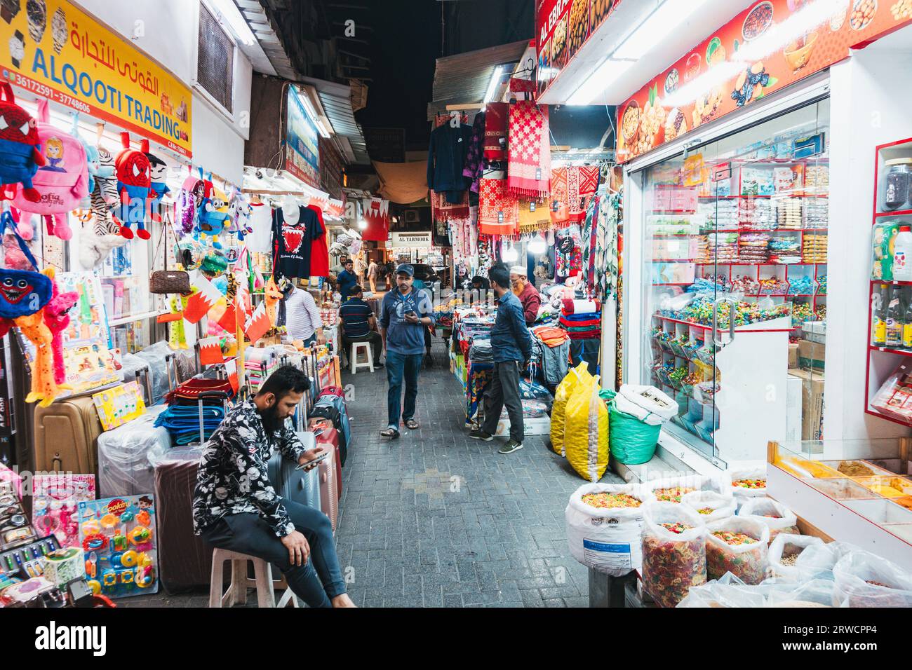a street full of shops selling clothing, toys and other household items ...