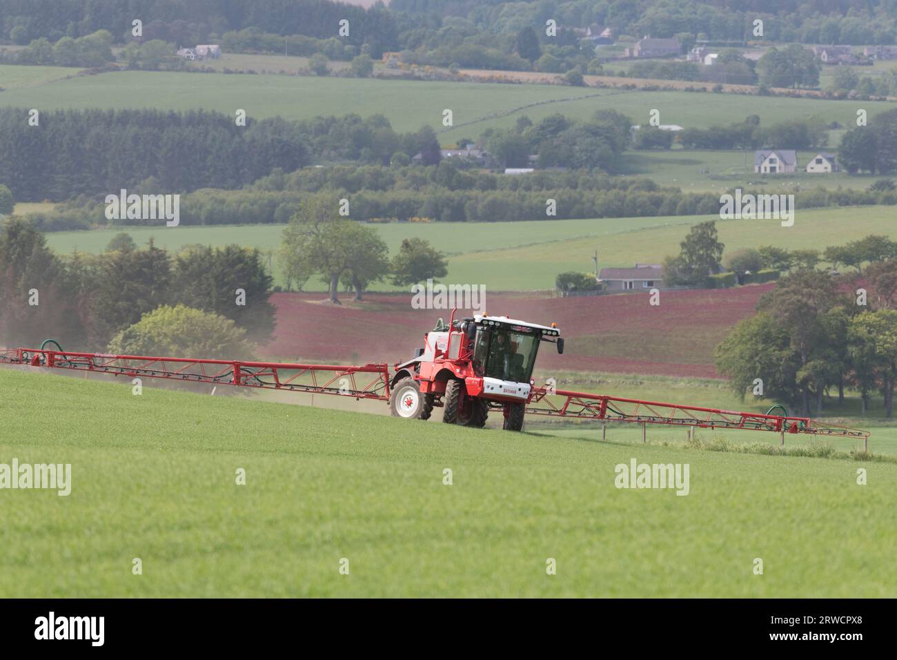 A Bateman 4000 Crop Sprayer Turning in a Field While Spraying a Crop of ...