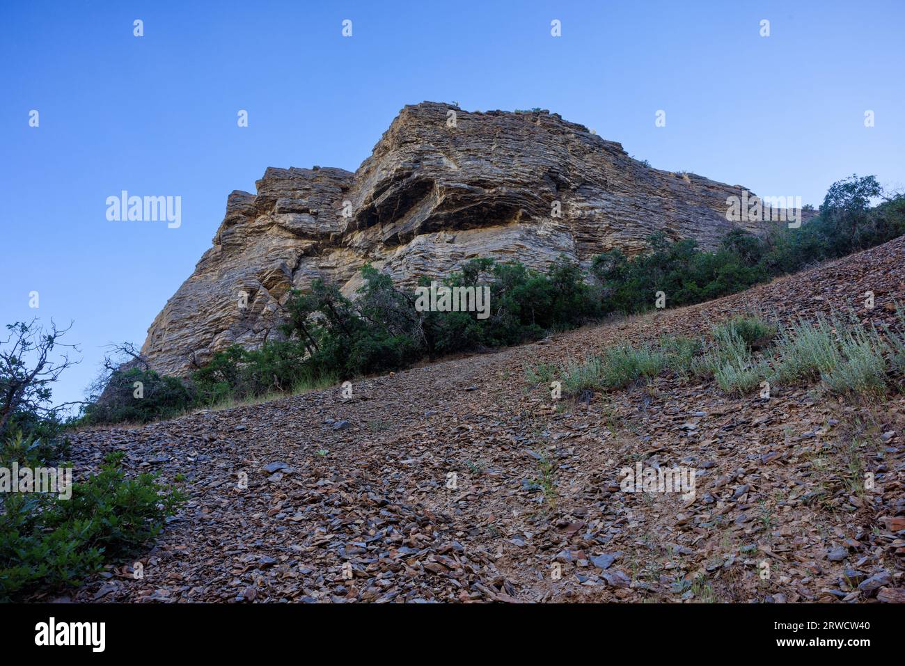 round mountain sitting atop rocky slope Stock Photo - Alamy