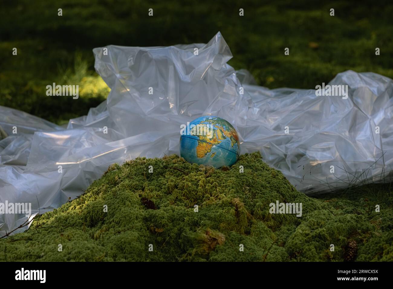 globe and plastic film green forest, Pollution of the environment. The ...