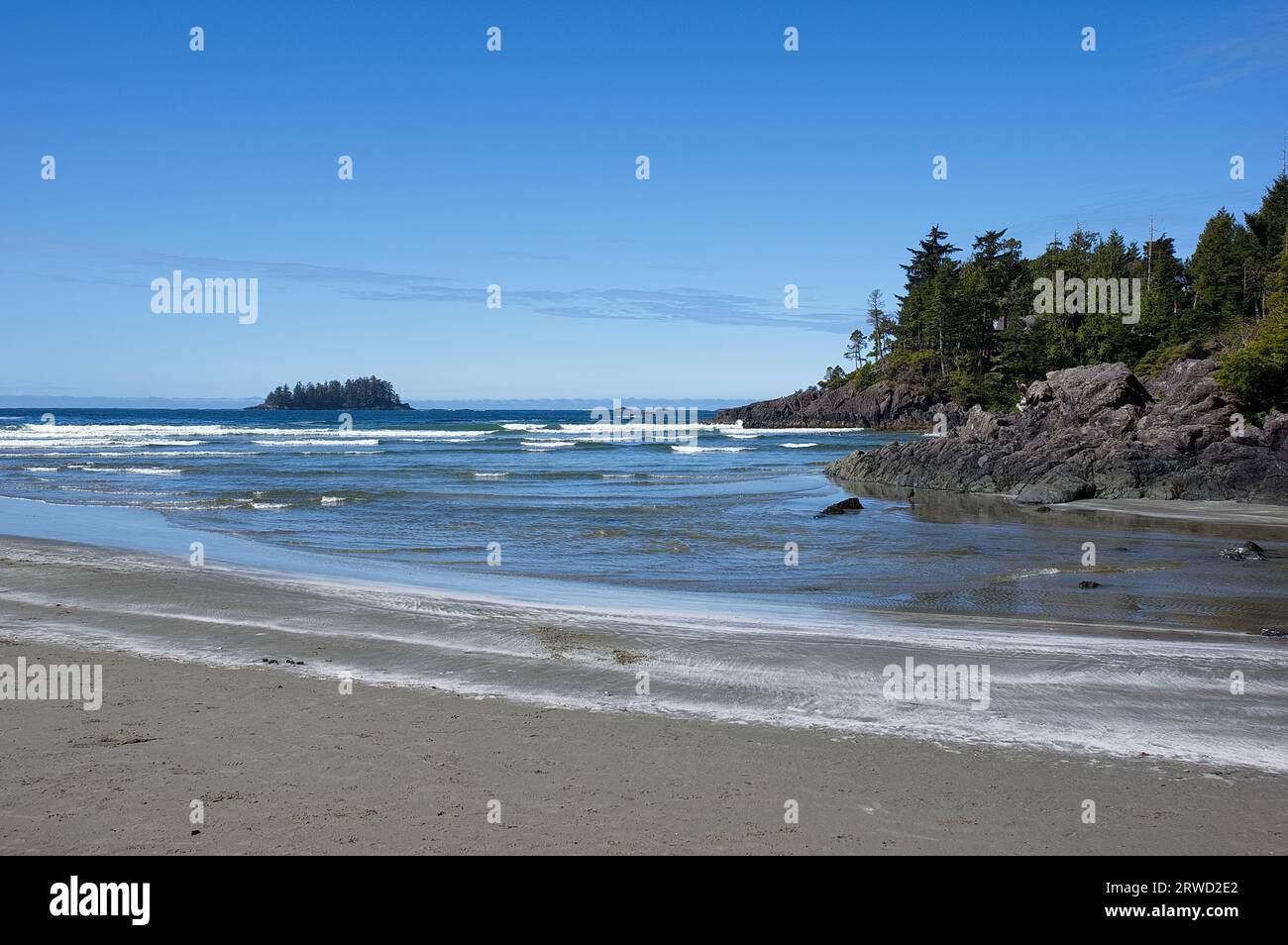 Clear water stream meeting the ocean on Mackenzie Beach near Tofino, BC ...