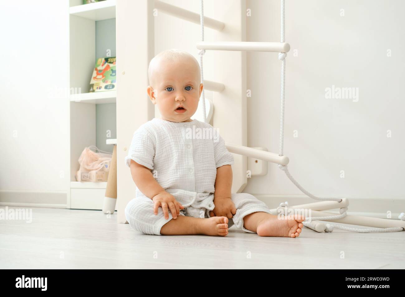 Child is exercising on Toddler Indoor Gym Playset. Kid climbing the ...